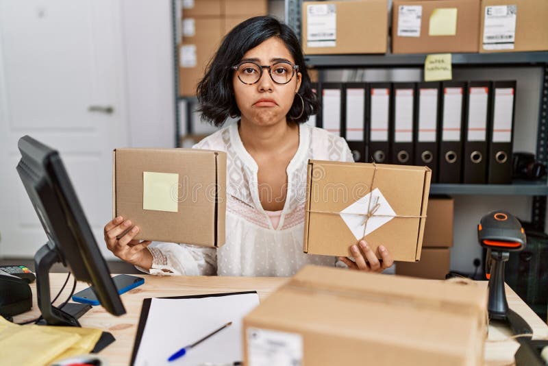 Young Hispanic Woman Working at Small Business Ecommerce Depressed and ...