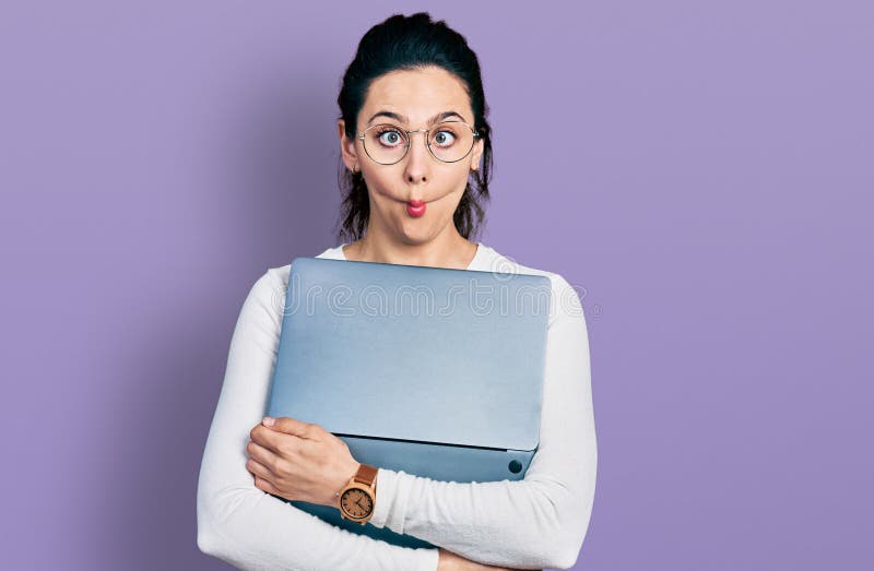 Young Hispanic Woman Working Using Computer Laptop Making Fish Face ...