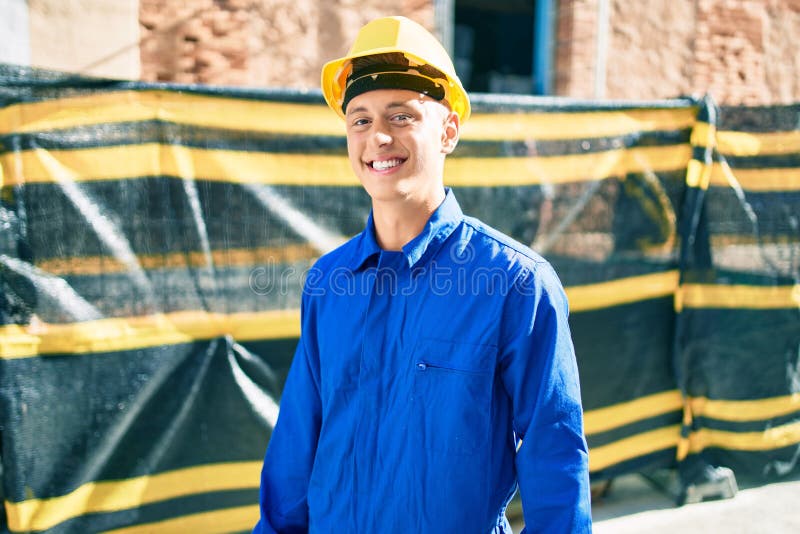 Young Hispanic Workman Smiling Happy Working at Street of City Stock ...