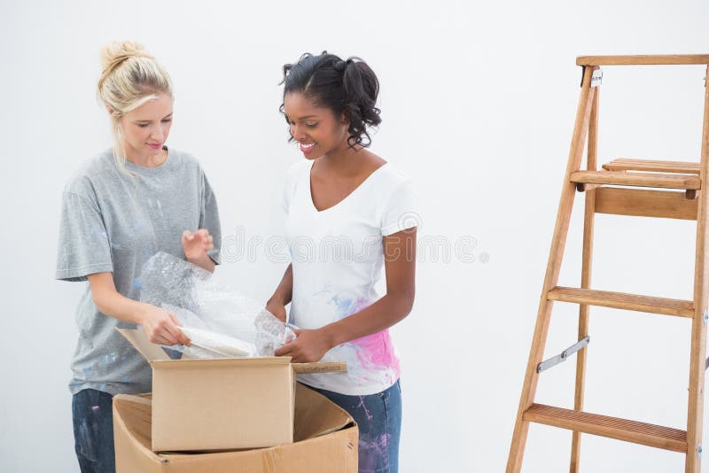 Young Housemates Unpacking Moving Boxes Stock Photo - Image of friend ...