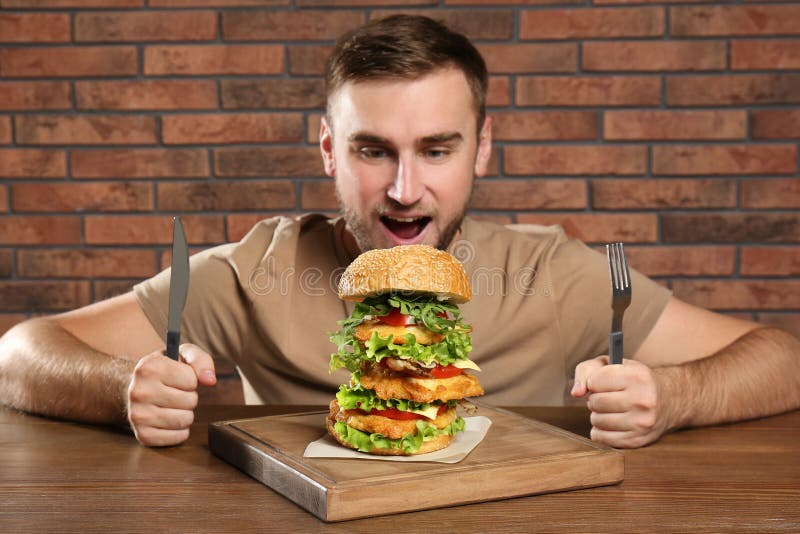 Young Hungry Man with Cutlery Eating Huge Burger Stock Image - Image of ...