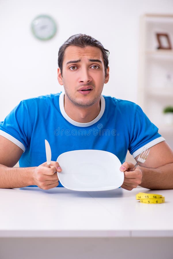 Young Hungry Man in Dieting Concept Stock Photo - Image of healthy ...