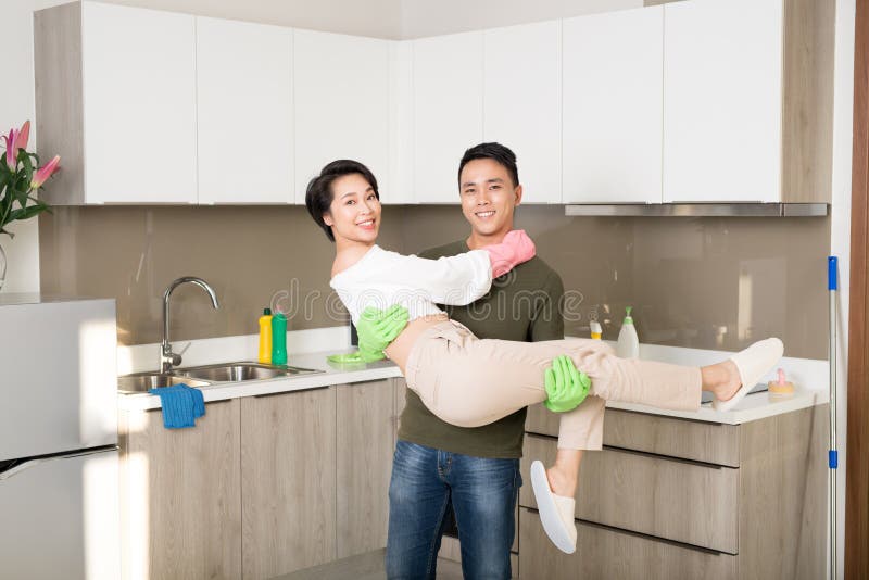 Young Husband Embracing His Wife while Cleaning the Kitchen Stock Image ...