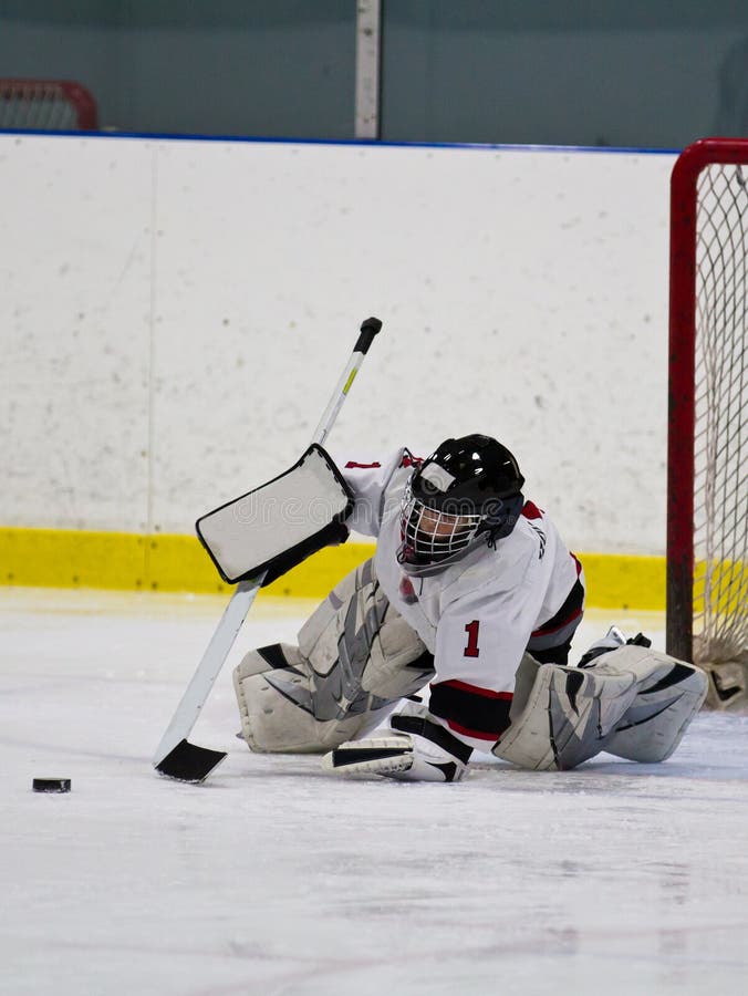 Young Ice Hockey Goaltender Making a Save Stock Photo - Image of rink ...