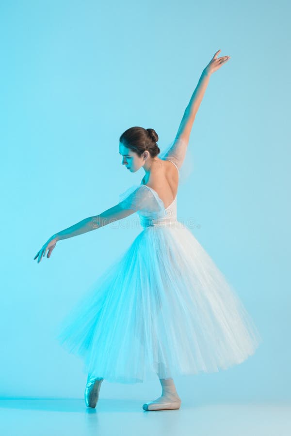 Young and Incredibly Beautiful Ballerina is Dancing in a Blue Studio ...
