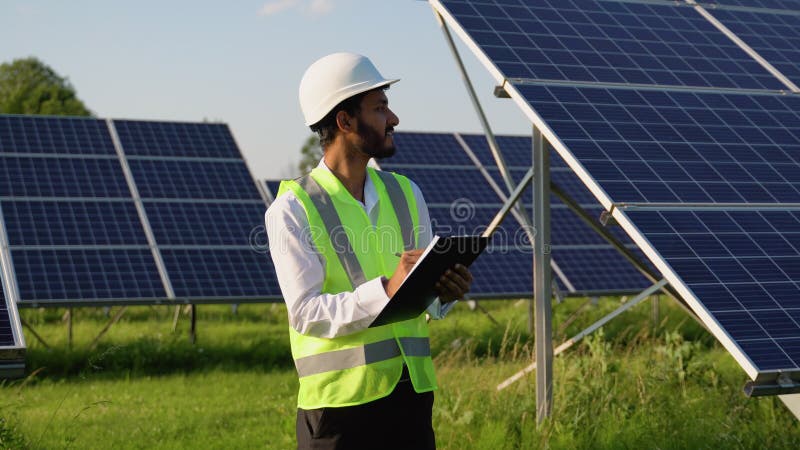 Young Indian Engineer in Special Uniform Stands on Background of Solar ...