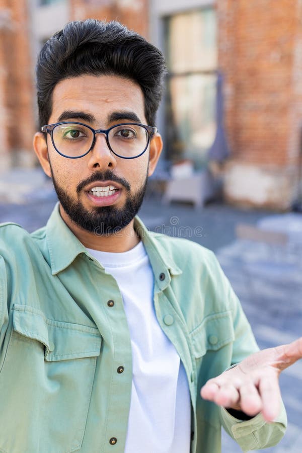 A Young Indian Guy is Having a Video Call on the Phone on the Street ...