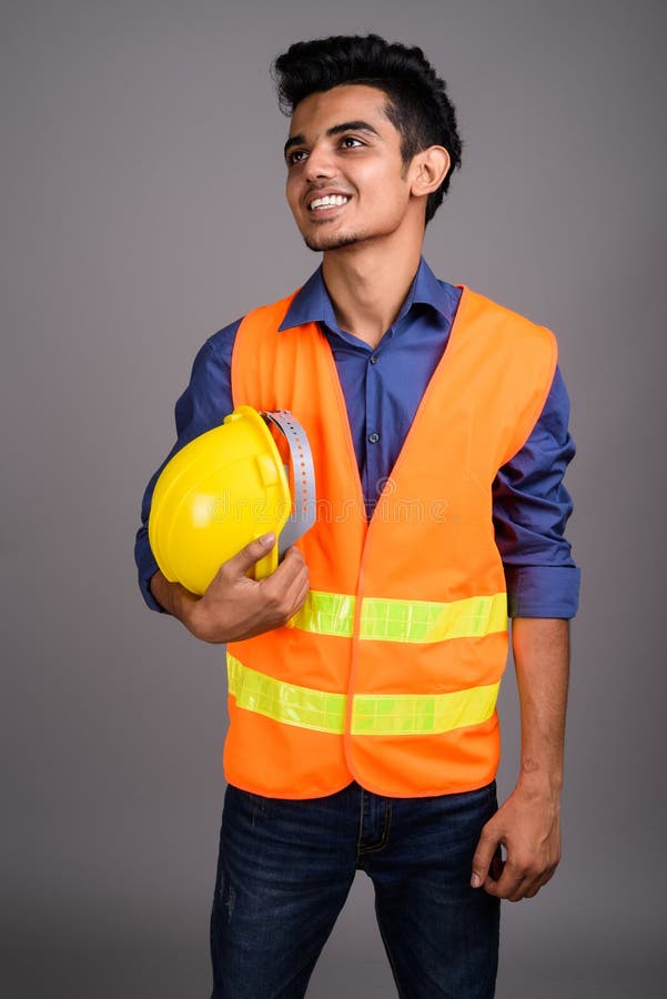 Young Indian Man Construction Worker Against Gray Background Stock ...