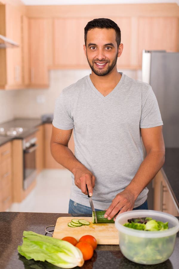 Young indian man cooking stock photo. Image of diner - 63087966