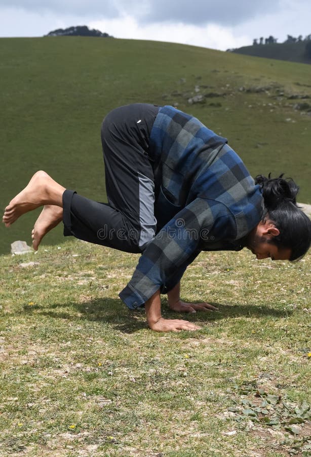 A Young Indian Man Doing Morning Exercise with Practicing Bakasana Yoga ...