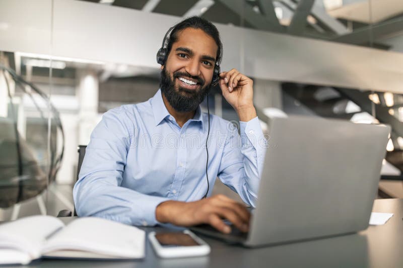 Young Indian Man Hotline Manager in Headset Using Computer Stock Photo ...