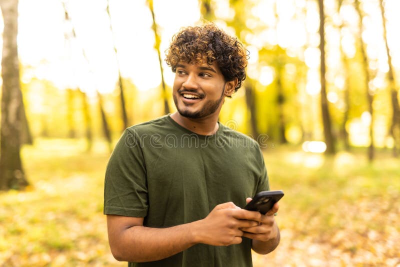 Young Indian Man Use Smartphone in the Autumn Park Stock Image - Image ...
