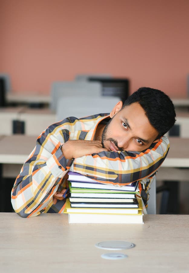 Young Indian Student Boy Reading Book Studying in College Library with ...