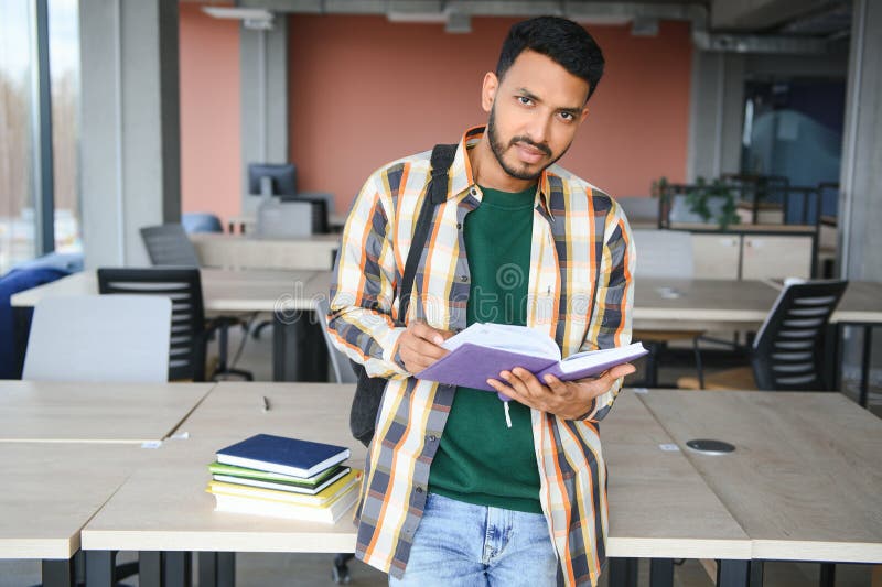 Young Indian Student Boy Reading Book Studying in College Library with ...