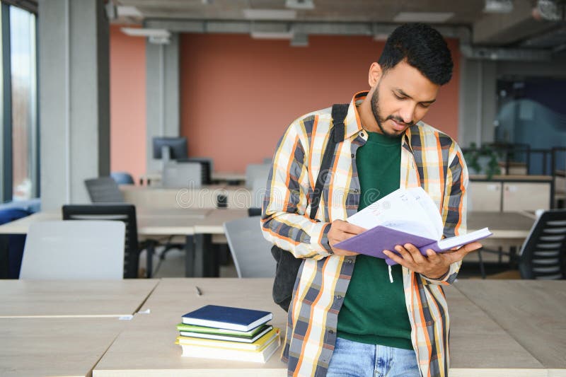 Young Indian Student Boy Reading Book Studying in College Library with ...
