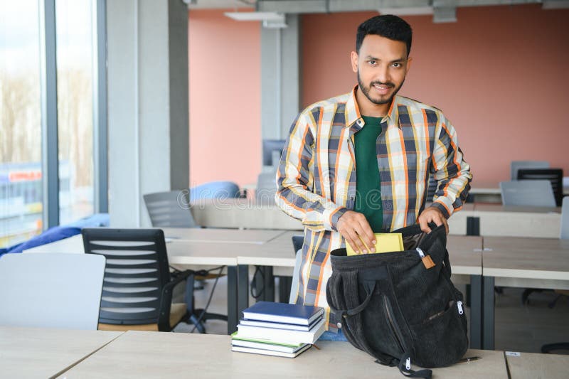 Young Indian Student Boy Reading Book Studying in College Library with ...