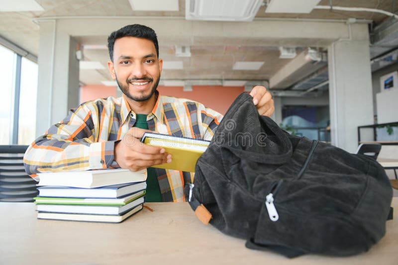 Young Indian Student Boy Reading Book Studying in College Library with ...