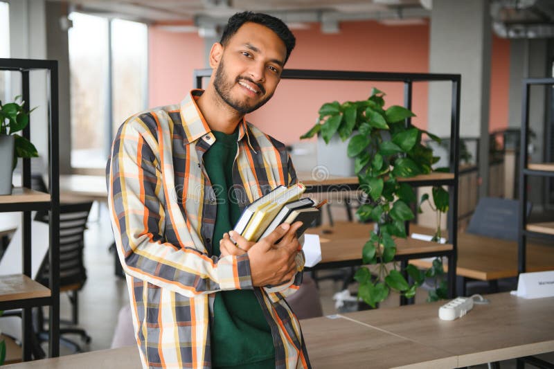 Young Indian Student Boy Reading Book Studying in College Library with ...