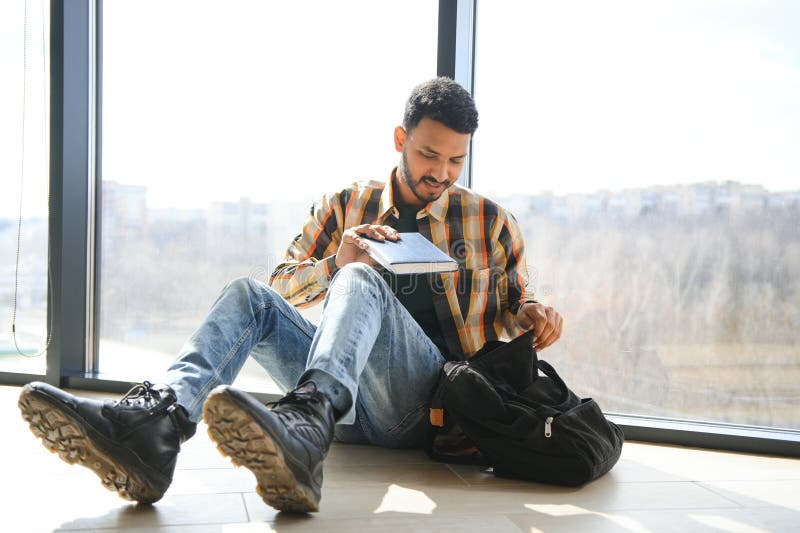 Young Indian Student Boy Reading Book Studying in College Library with ...