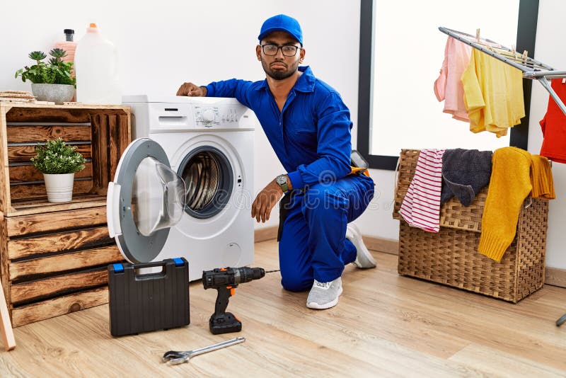 Young Indian Technician Working on Washing Machine Depressed and Worry ...