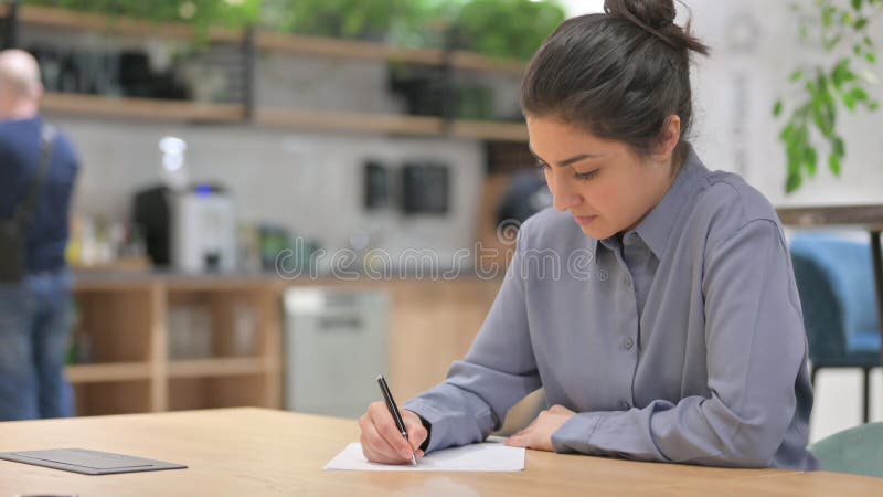 Young Indian Woman Writing on Paper at Work Stock Photo - Image of ...