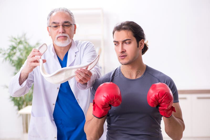 Young Injured Boxer Visiting Old Doctor Traumatologist Stock Photo ...