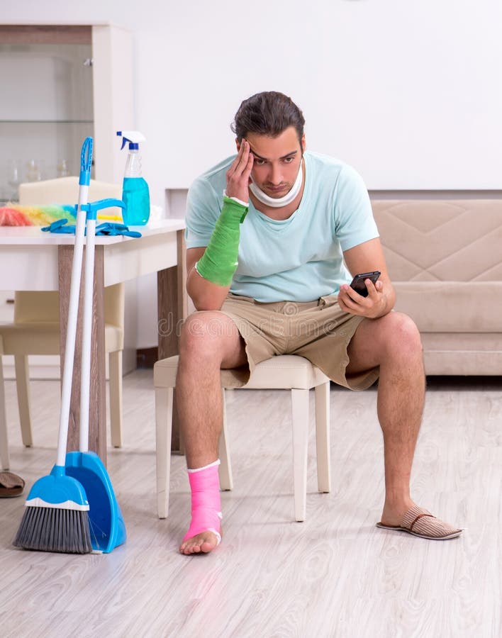 Young Injured Man Cleaning the House Stock Photo - Image of foot ...