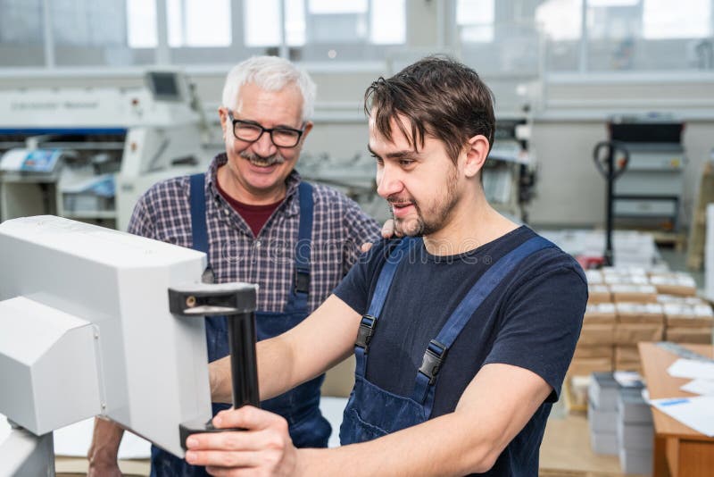 Young Intern of Printing Factory Operating Machine Stock Image - Image ...