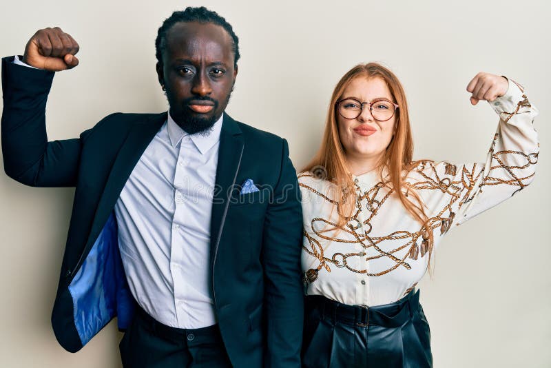 Young Interracial Couple Wearing Business And Elegant Clothes Strong