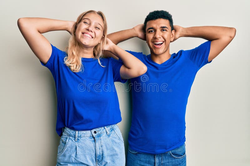 Young Interracial Couple Wearing Casual Clothes Relaxing And Stretching