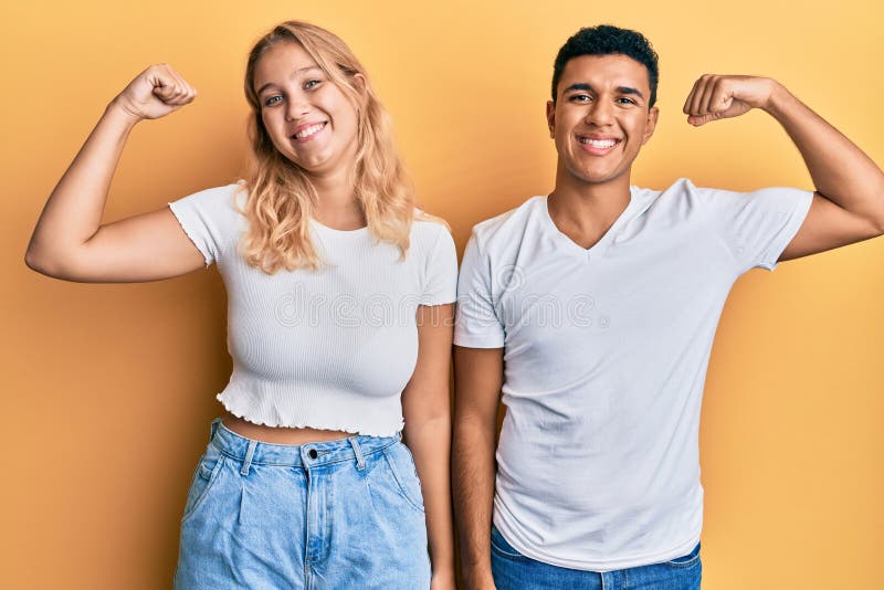 Young Interracial Couple Wearing Casual White Tshirt Showing Arms