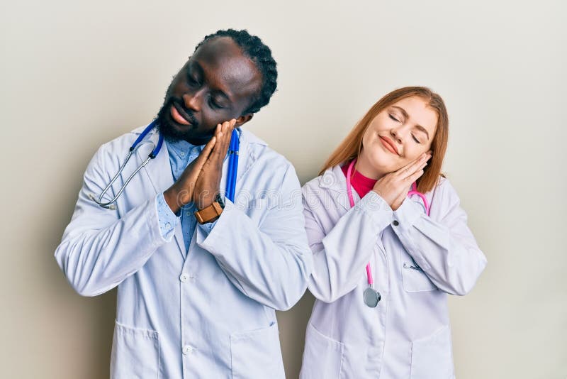 Young Interracial Couple Wearing Doctor Uniform And Stethoscope