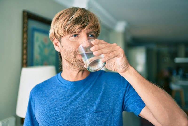 Young Irish Man Drinking Glass of Water Standing at Home Stock Photo ...