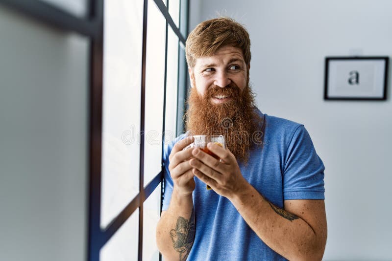 Young Irish Man Drinking Tea Standing by the Window at Home Stock Photo ...