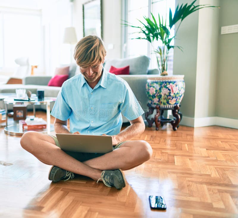 Young Irish Man Smiling Happy Working Using Laptop and Smartphone at ...