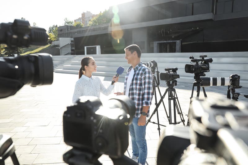 Young Journalist Interviewing Man on City Street Stock Photo - Image of ...
