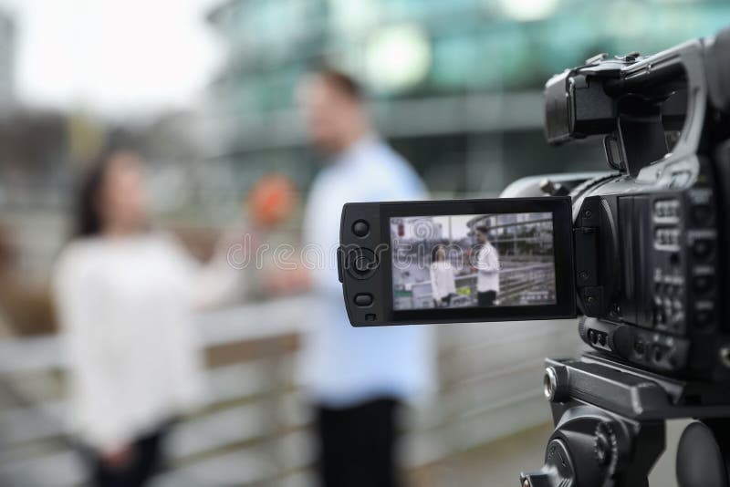 Young Journalist Interviewing Man on Street, Focus on Camera Display ...