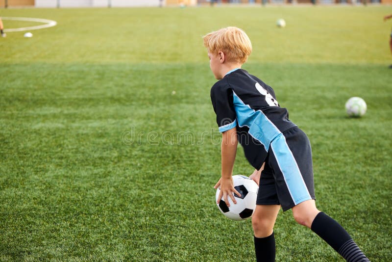 Young Kid Boy Training with Ball Alone in Stadium Stock Image - Image ...