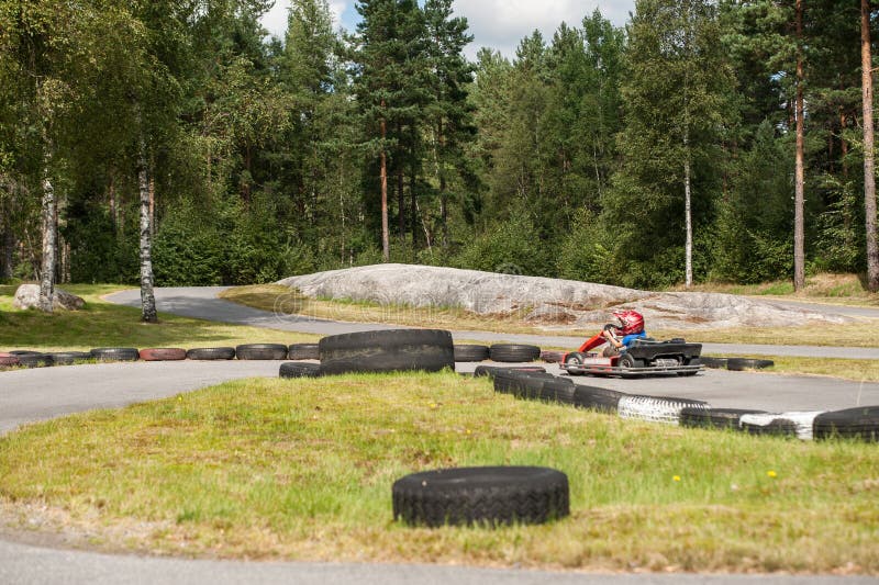 Young Kid Driving a Go Cart Round a Track in Summer.. Stock Photo ...