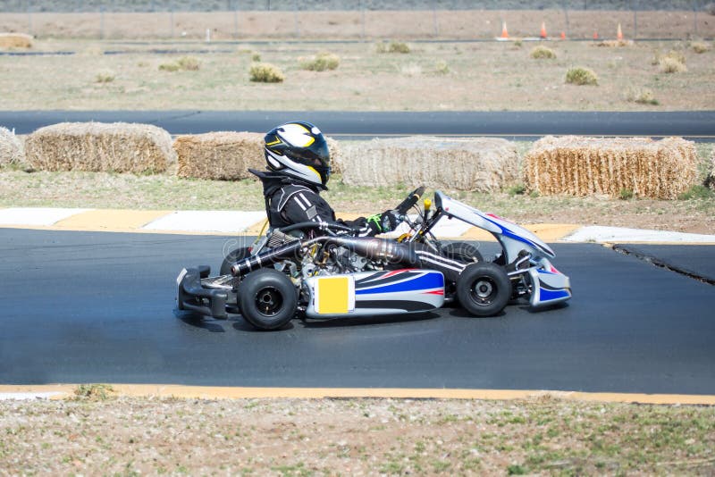 Young kid racing a go cart stock image. Image of cart - 82382261
