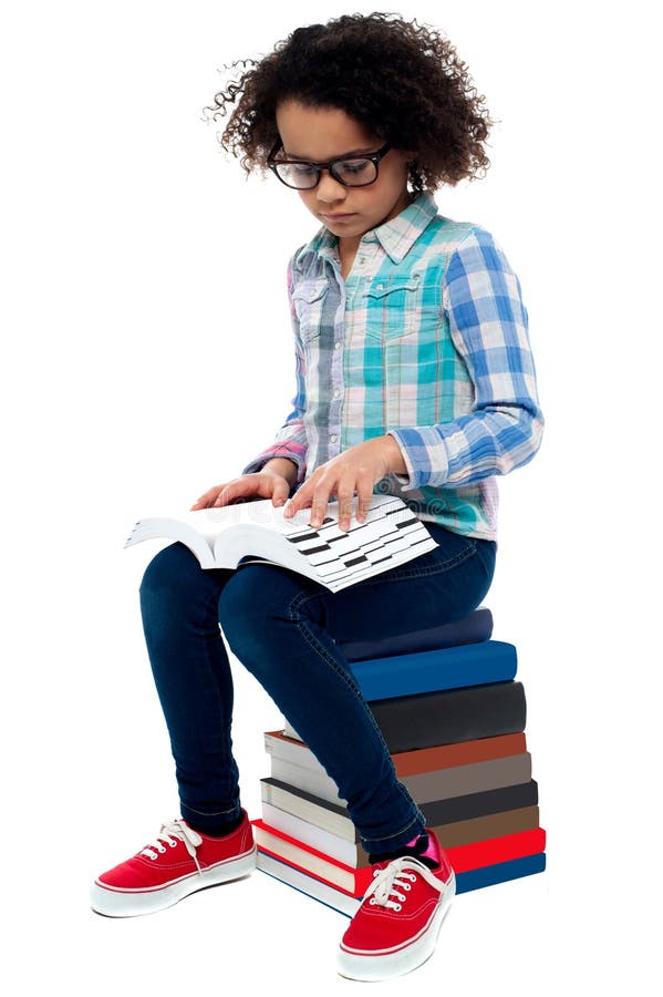 Young Kid Sitting on Stack of Books and Reading Stock Image - Image of ...