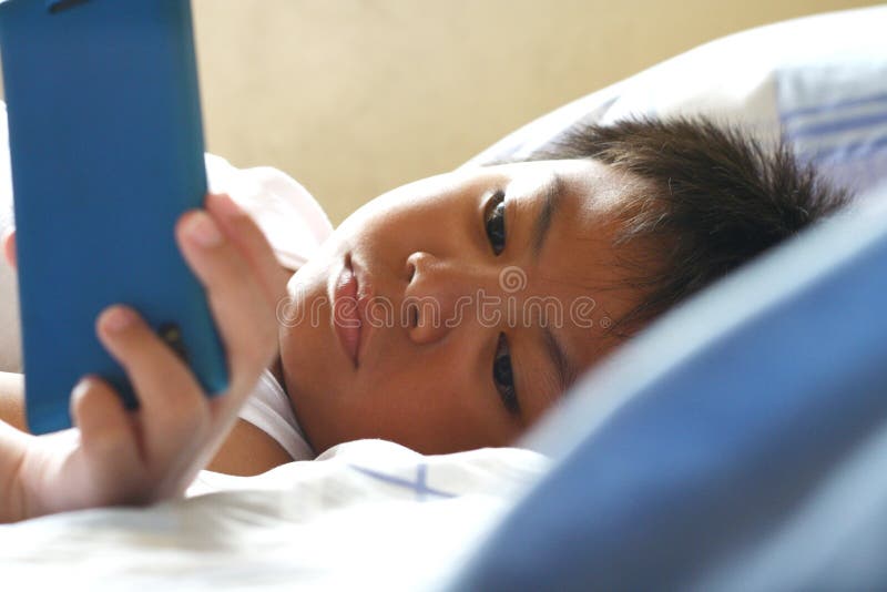 Young Kid Watching on a Smartphone Stock Image - Image of optical ...