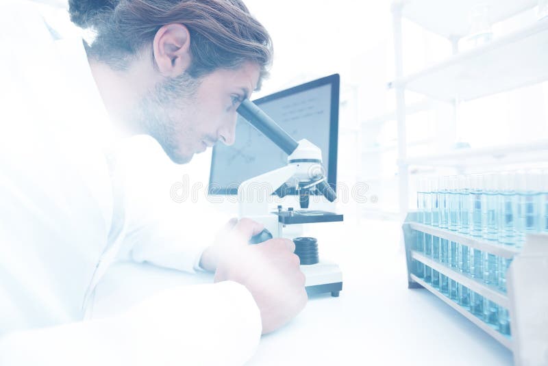 Young Laboratory Scientist Looking at Microscope in Laboratory Stock ...