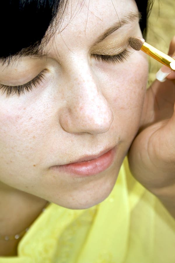 Young lady applying makeup stock image. Image of brunette - 10610841
