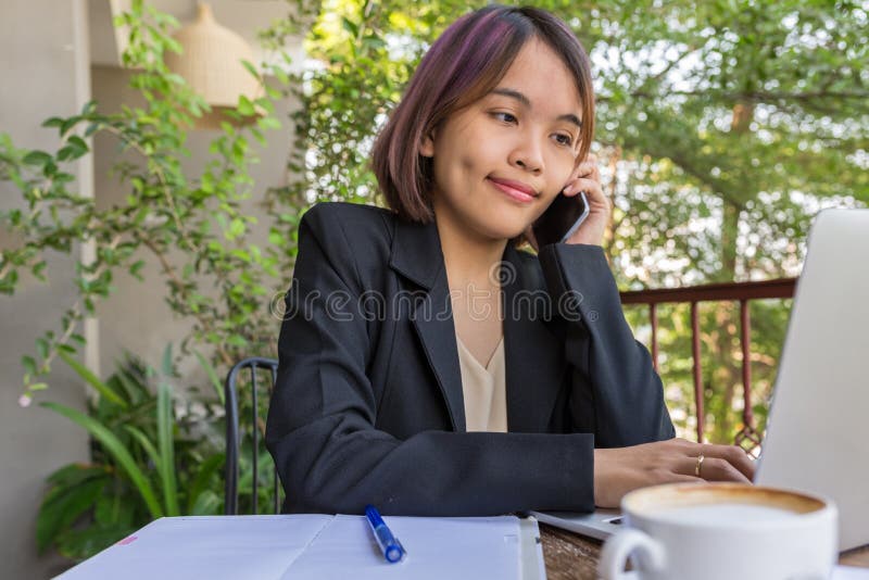 Young Lady in Black Suit Using Mobile Phone and Laptop Stock Image ...