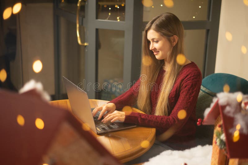 Young Woman Browsing the Internet at the Cafe in the Evening Stock ...