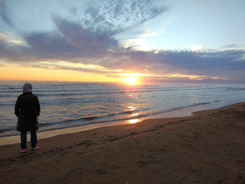 The Young Lady is Enjoying the Sunset on the Beach Stock Photo - Image ...