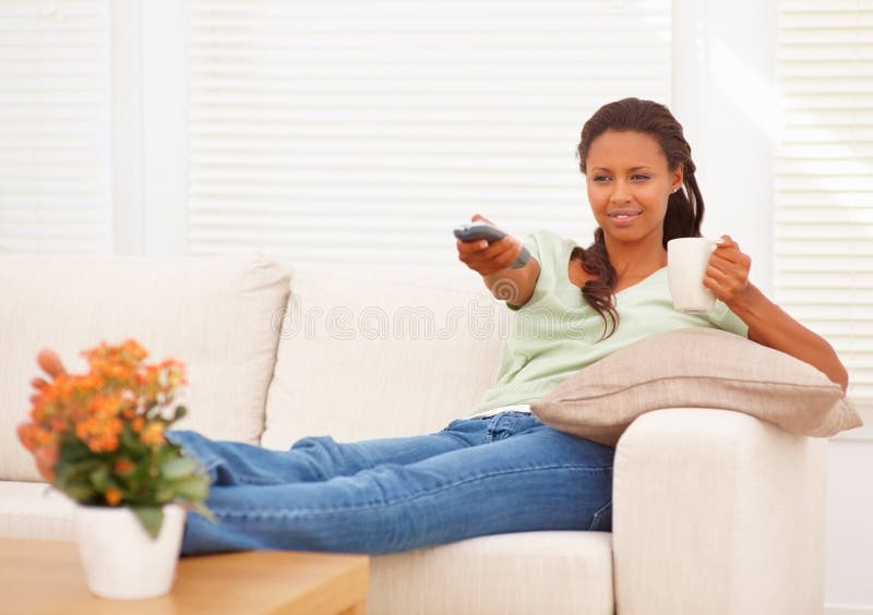 Young Lady Holding a Remote while Drinking Coffee Stock Photo - Image ...
