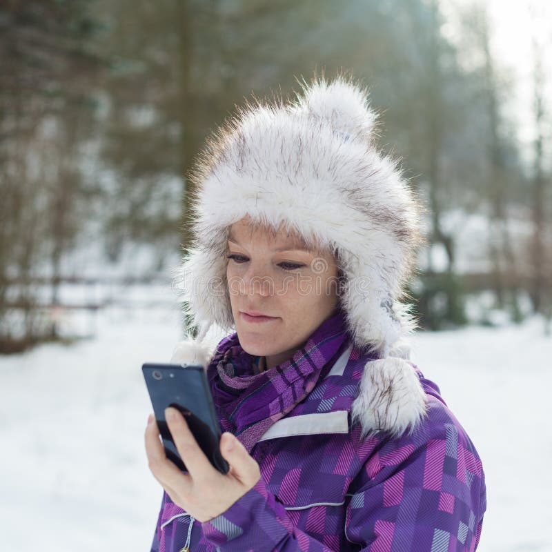A Young Lady Looking into the Mobile Phone Stock Image - Image of house ...