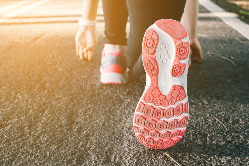 Young Lady Running on Road Closeup on Shoe., at Time Sunset Stock Photo ...